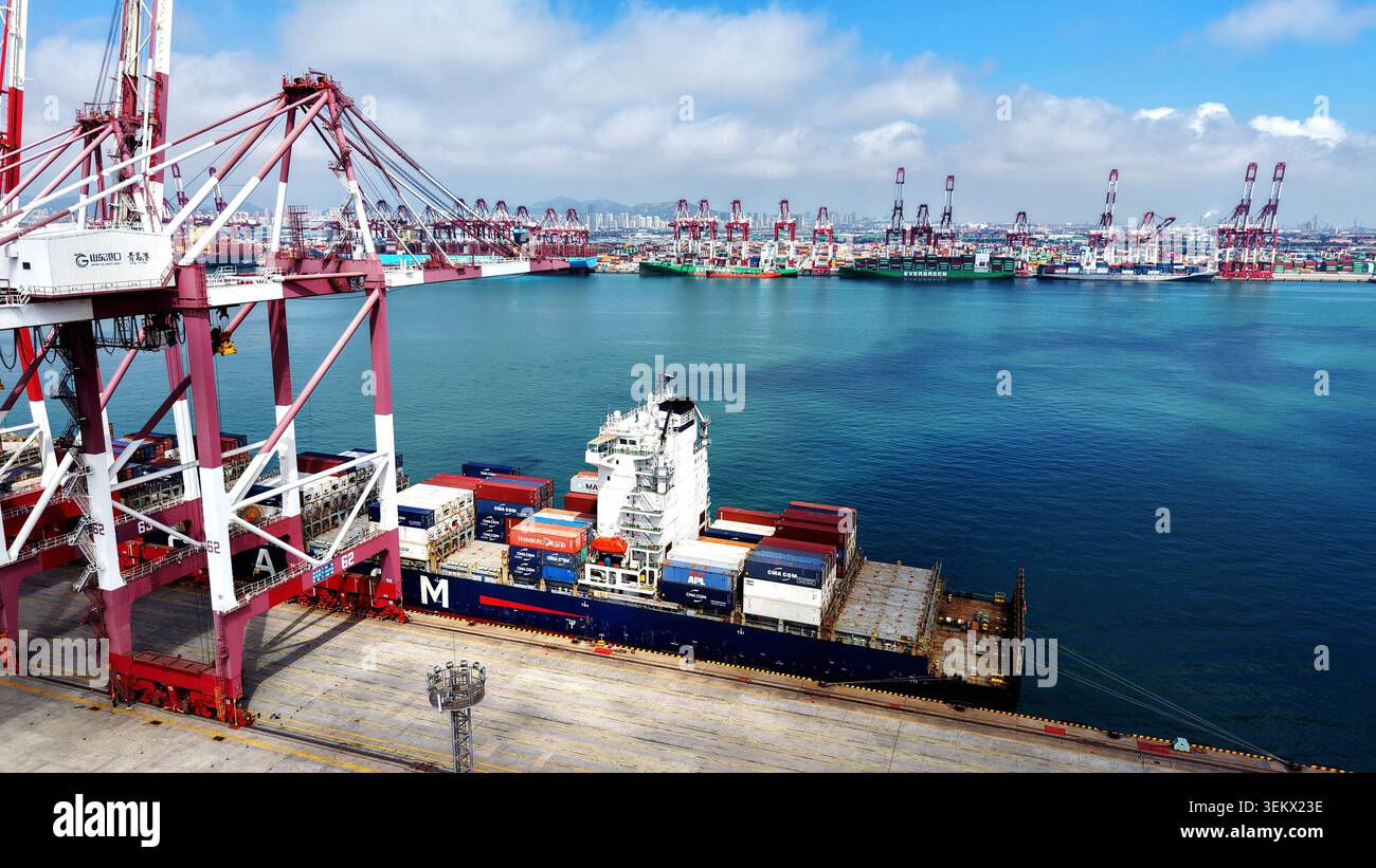 Workers transport foreign trade containers at Qingdao Port in east ...