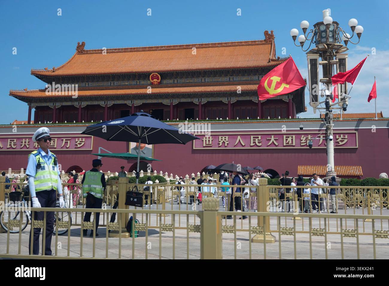 Flags bearing the hammer and sickle symbol are flown in front of ...