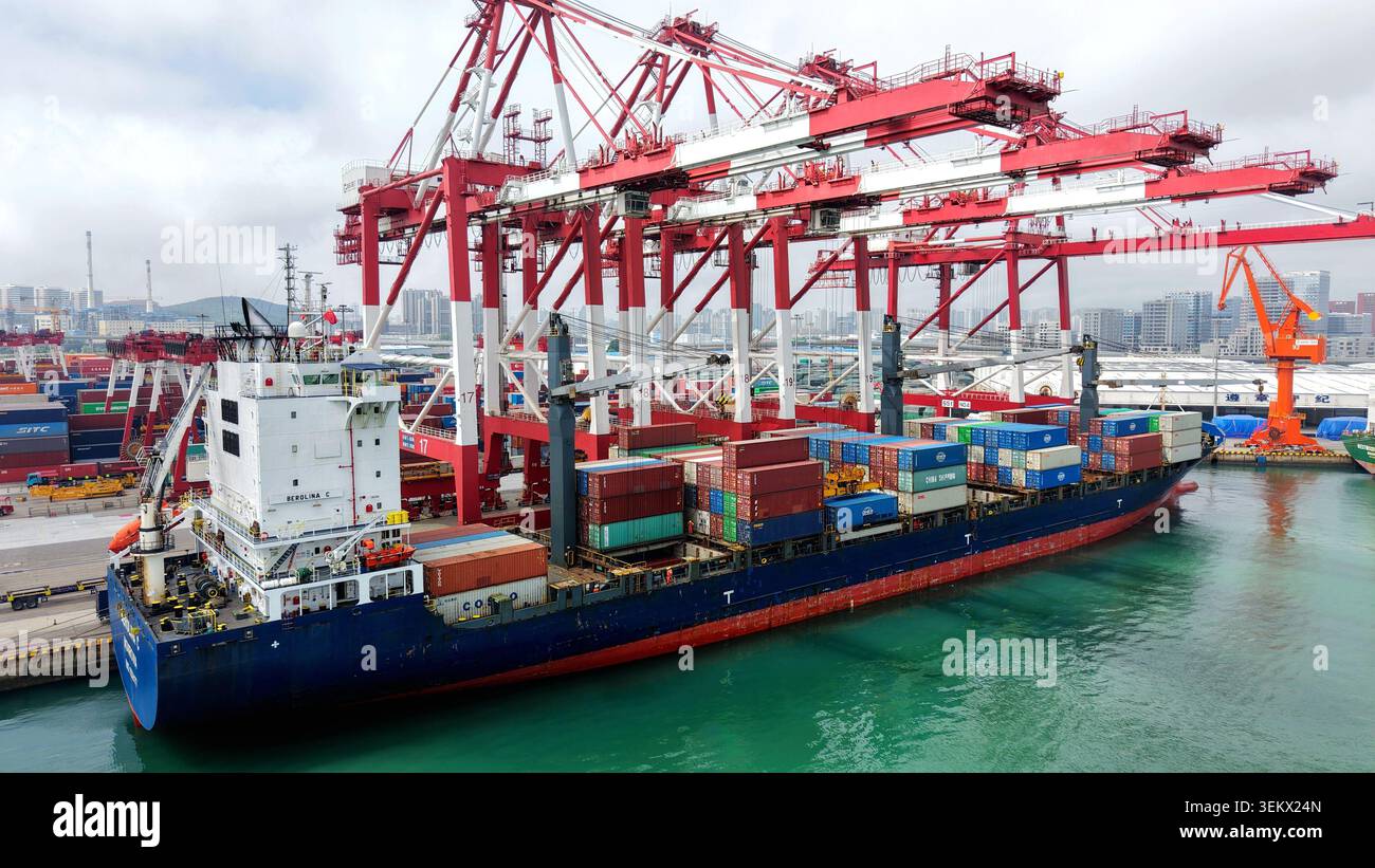 Workers transport foreign trade containers at Qingdao Port in east ...