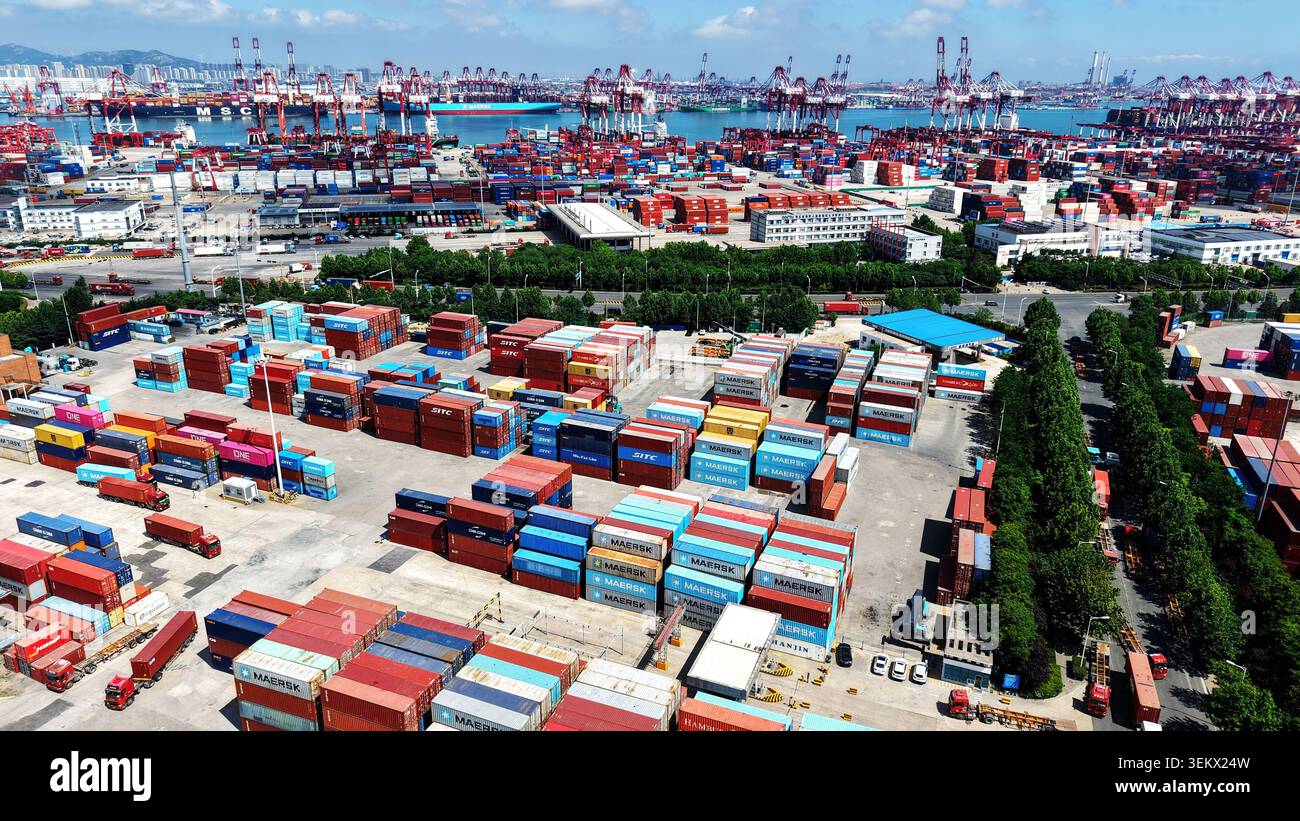 Workers transport foreign trade containers at Qingdao Port in east ...