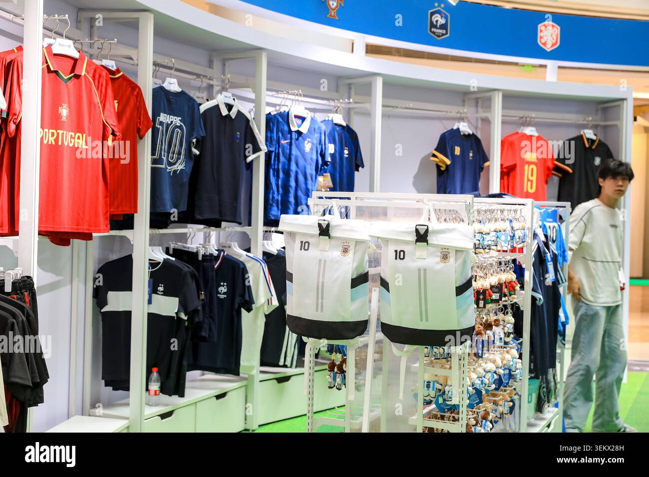 A stall sells official merchandise of World Cup teams including ...