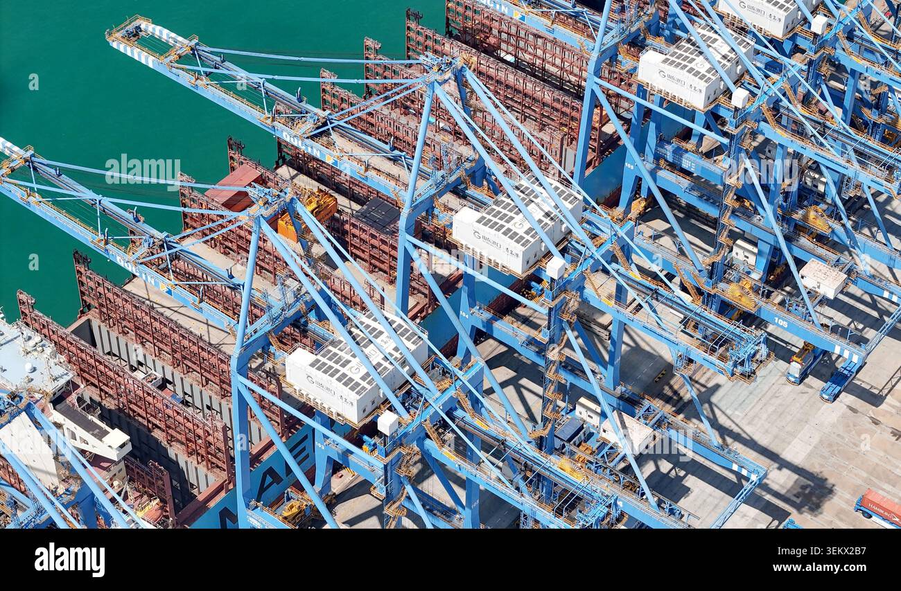 A cargo ship loads and unloads goods at the fully automated terminal of ...