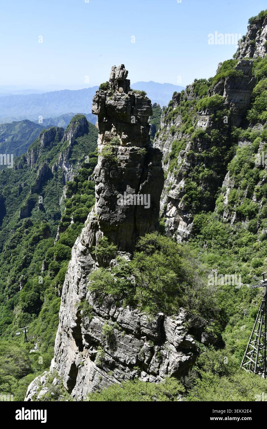 Tourists visit the snow-covered rocks at Baiyun Mountain Scenic Area in ...