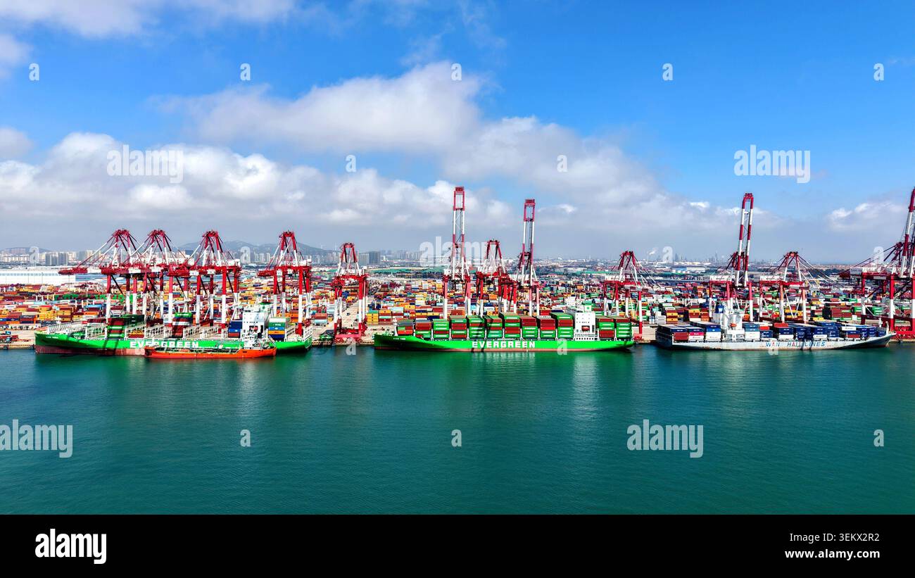 Workers transport foreign trade containers at Qingdao Port in east ...
