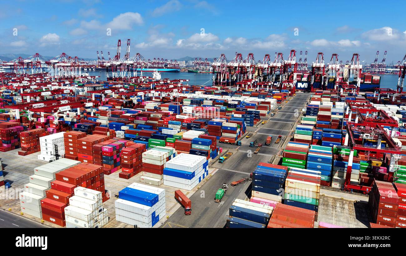Workers transport foreign trade containers at Qingdao Port in east ...