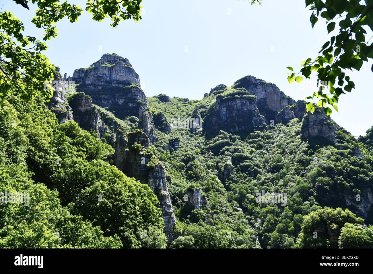 Tourists visit the snow-covered rocks at Baiyun Mountain Scenic Area in ...