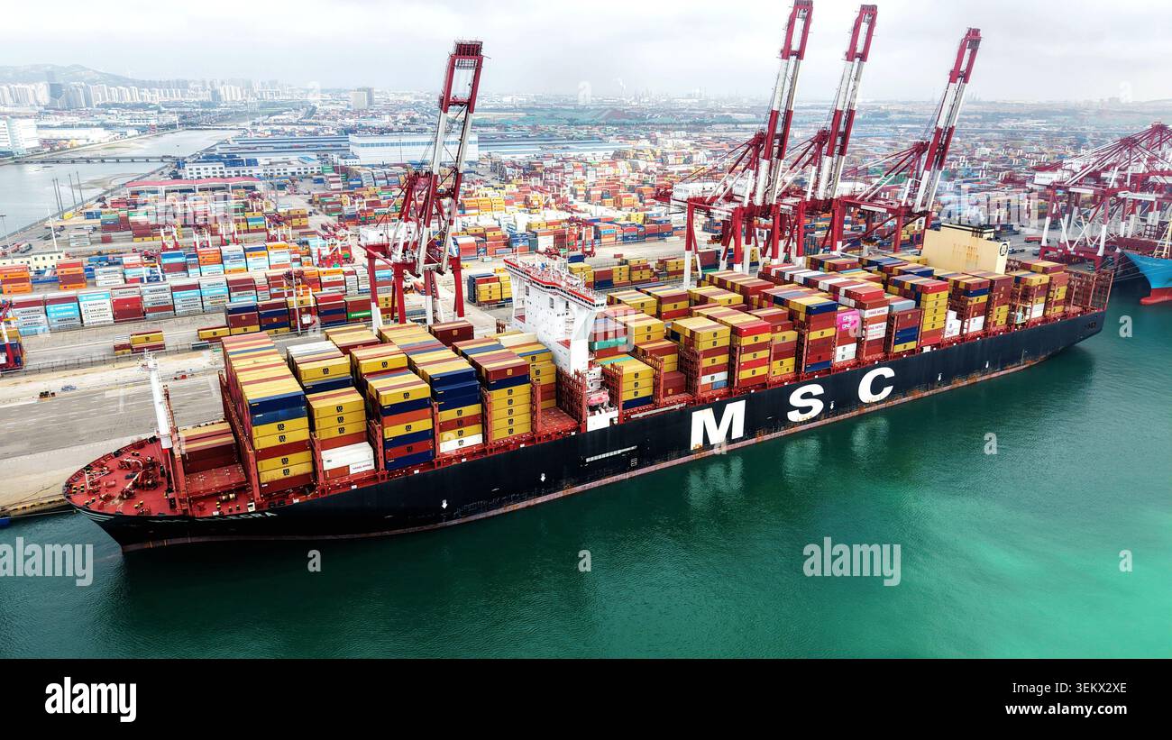 Workers transport foreign trade containers at Qingdao Port in east ...