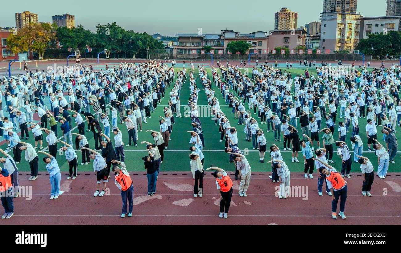 Over 1,900 senior high school students practice yoga under professional ...