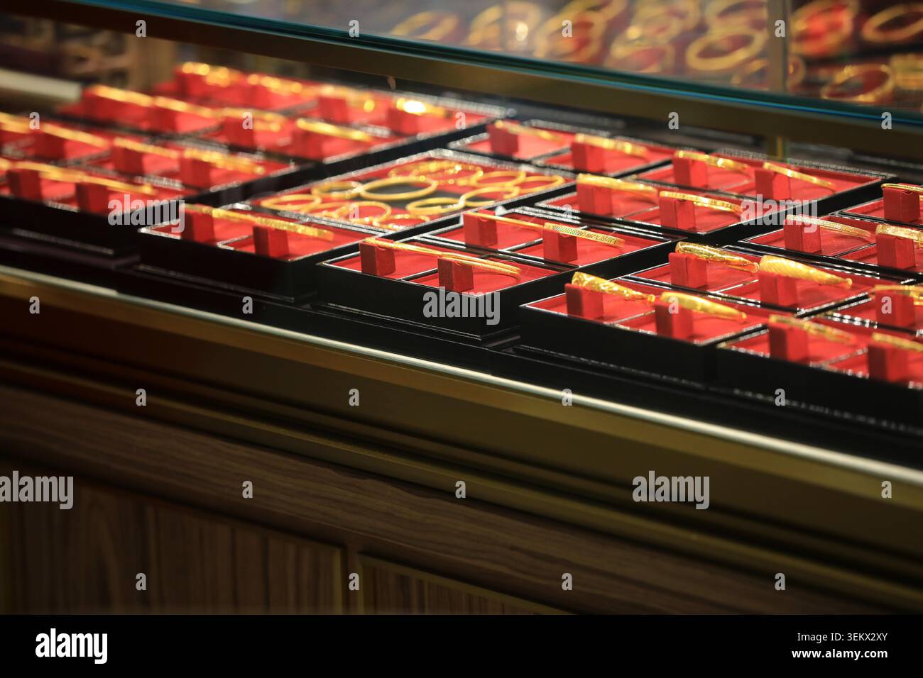 A consumer selects gold jewelry at a store in Huai'an, east China's ...