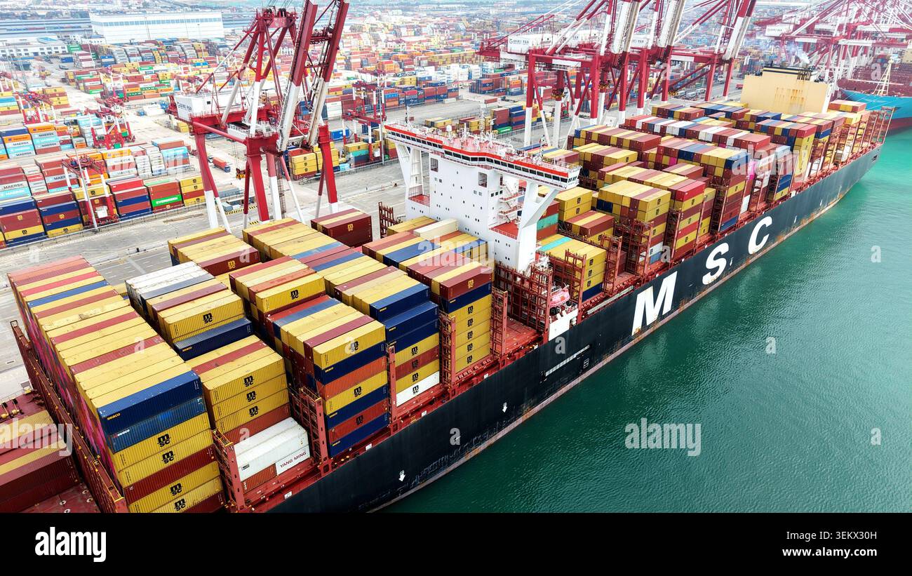 Workers transport foreign trade containers at Qingdao Port in east ...