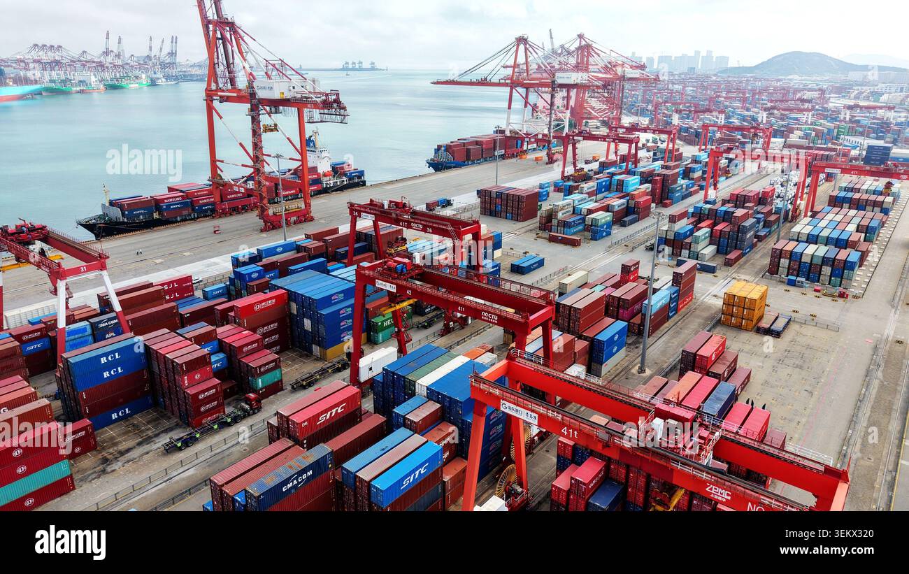 Workers transport foreign trade containers at Qingdao Port in east ...