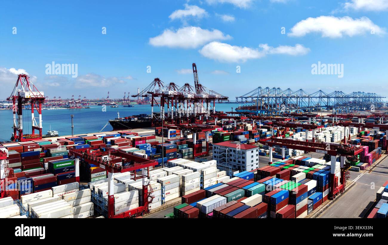 Workers transport foreign trade containers at Qingdao Port in east ...