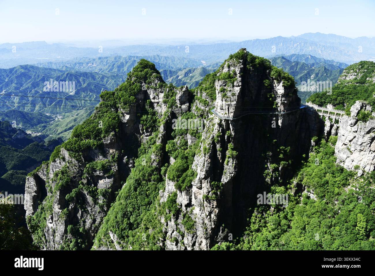 Tourists visit the snow-covered rocks at Baiyun Mountain Scenic Area in ...