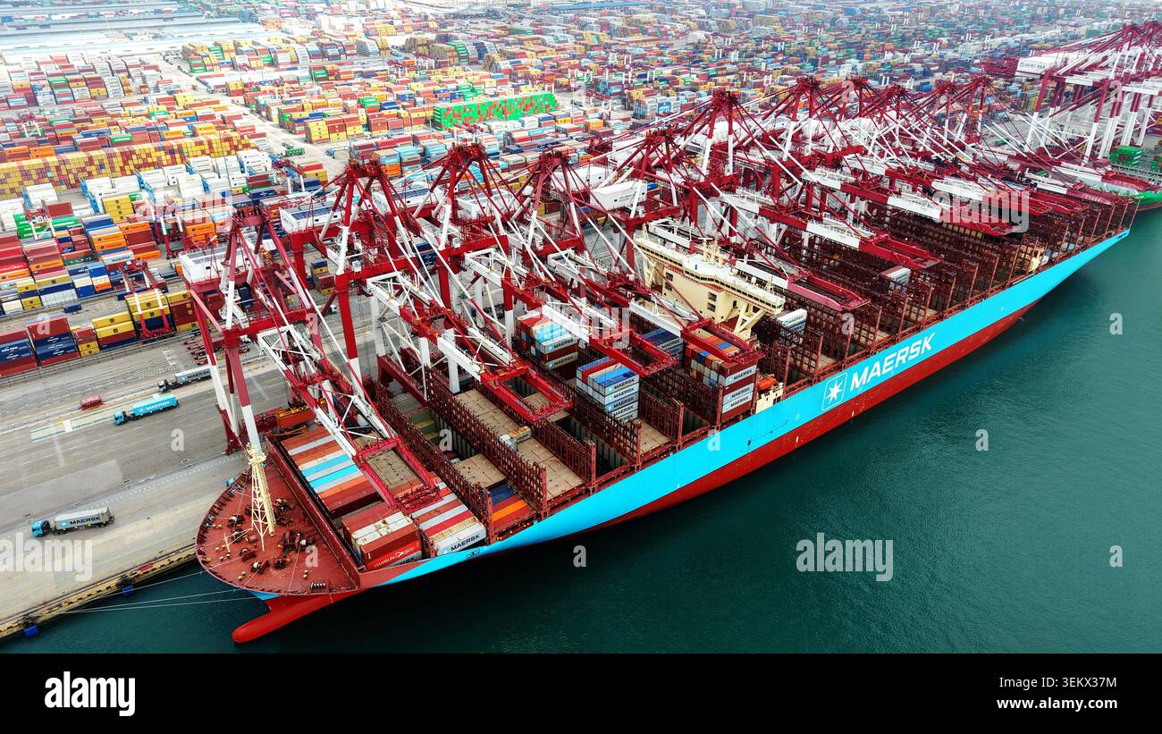 Workers transport foreign trade containers at Qingdao Port in east ...