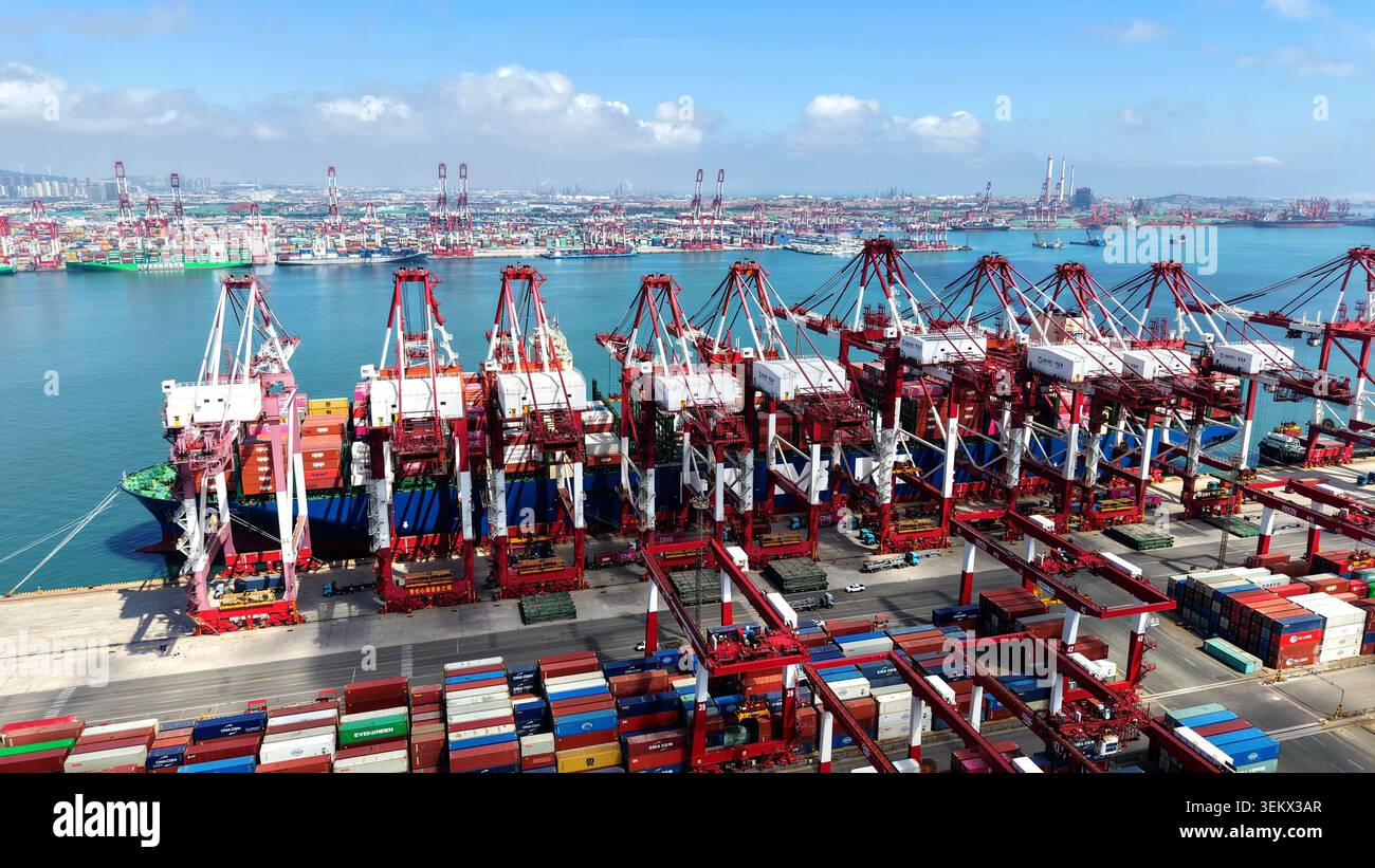 Workers transport foreign trade containers at Qingdao Port in east ...