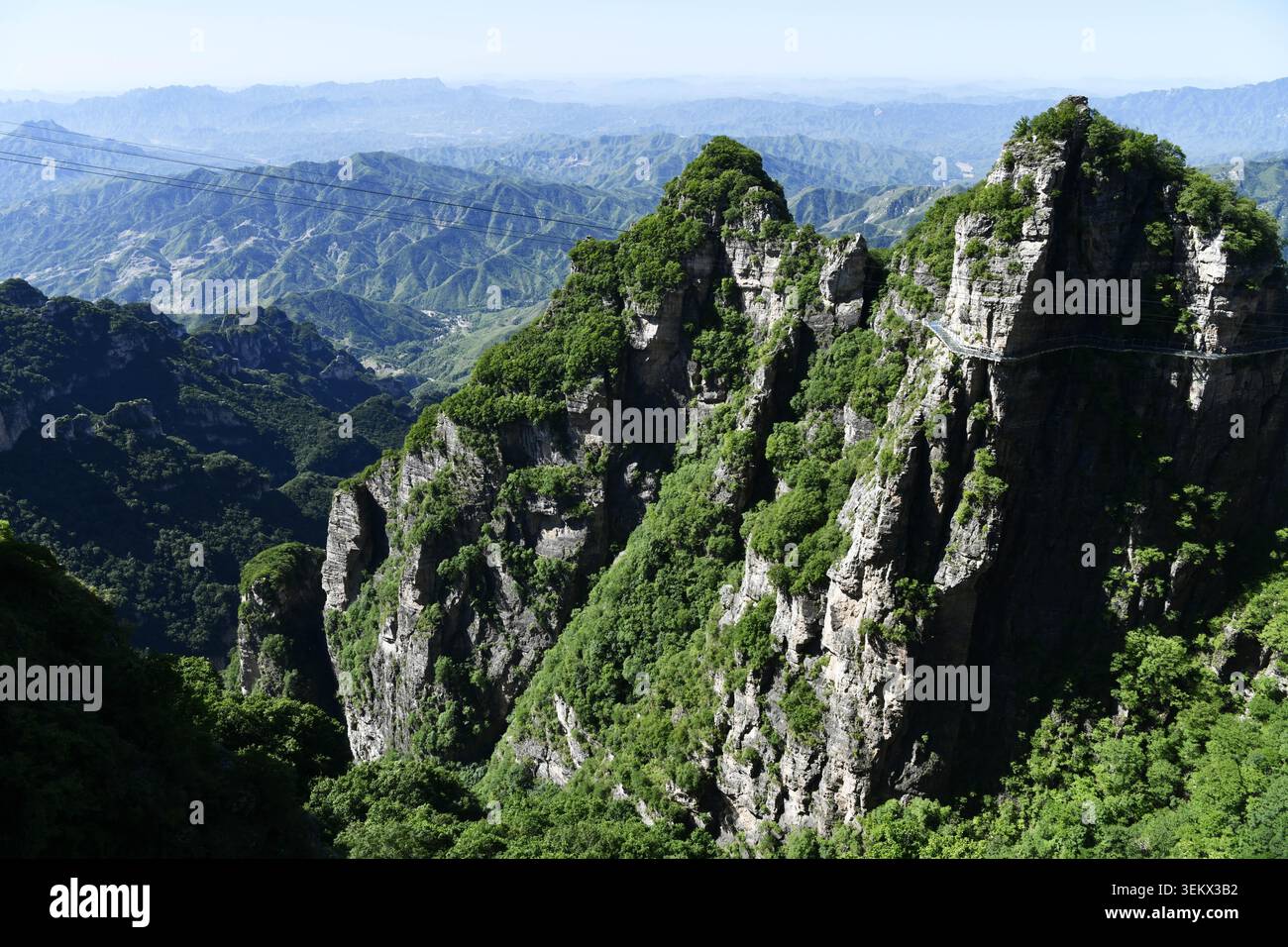 Tourists visit the snow-covered rocks at Baiyun Mountain Scenic Area in ...