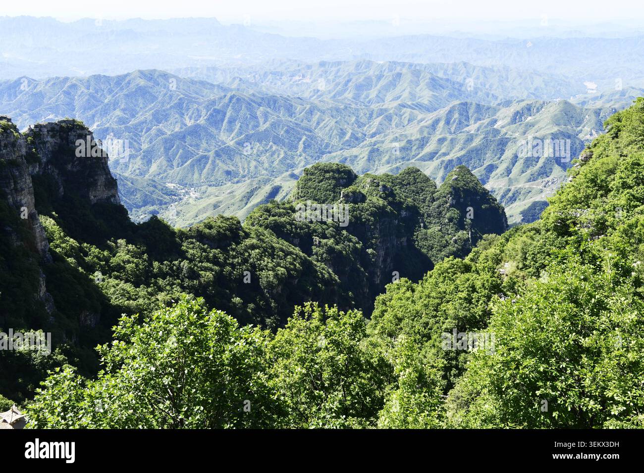 Tourists visit the snow-covered rocks at Baiyun Mountain Scenic Area in ...