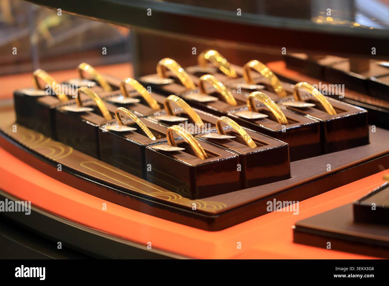 A consumer selects gold jewelry at a store in Huai'an, east China's ...