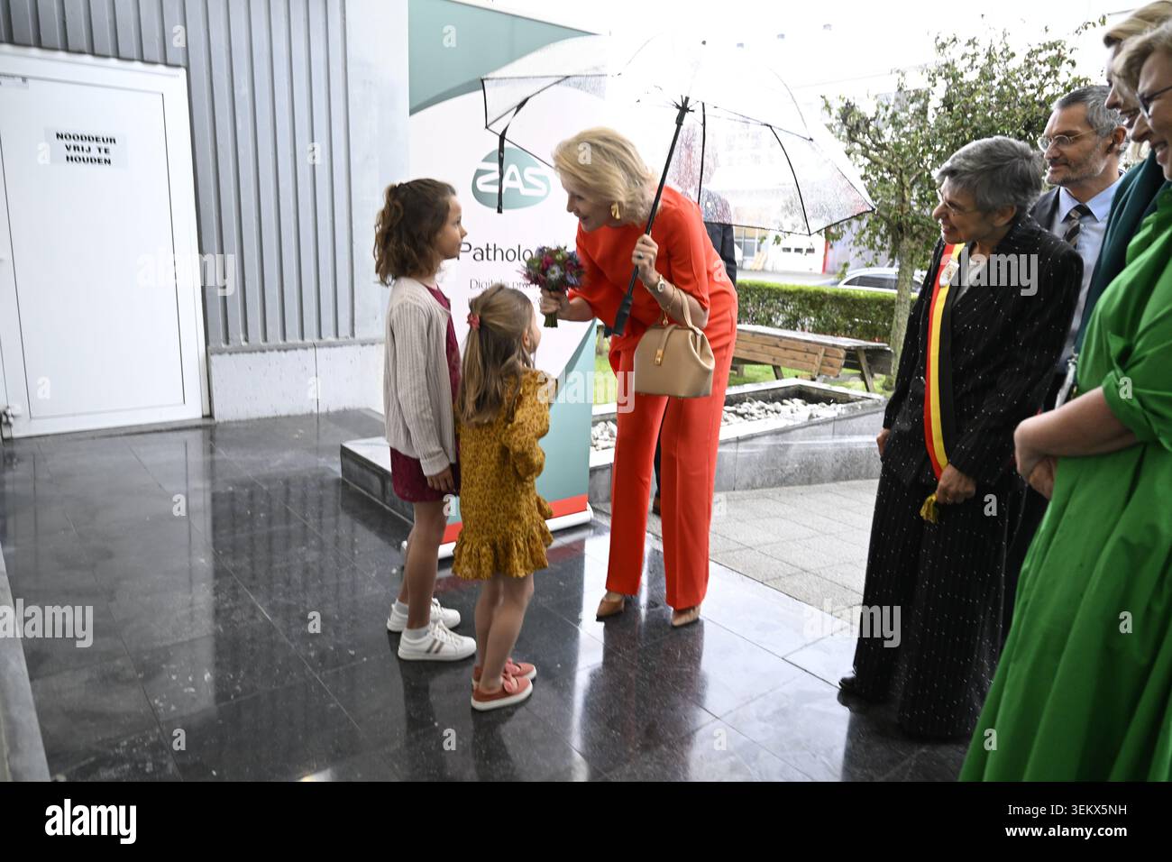 Queen Mathilde of Belgium receives flowers from girls as she arrives ...
