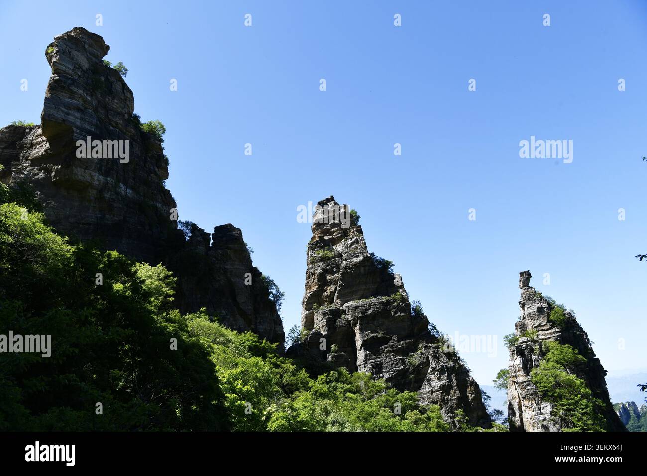 Tourists visit the snow-covered rocks at Baiyun Mountain Scenic Area in ...