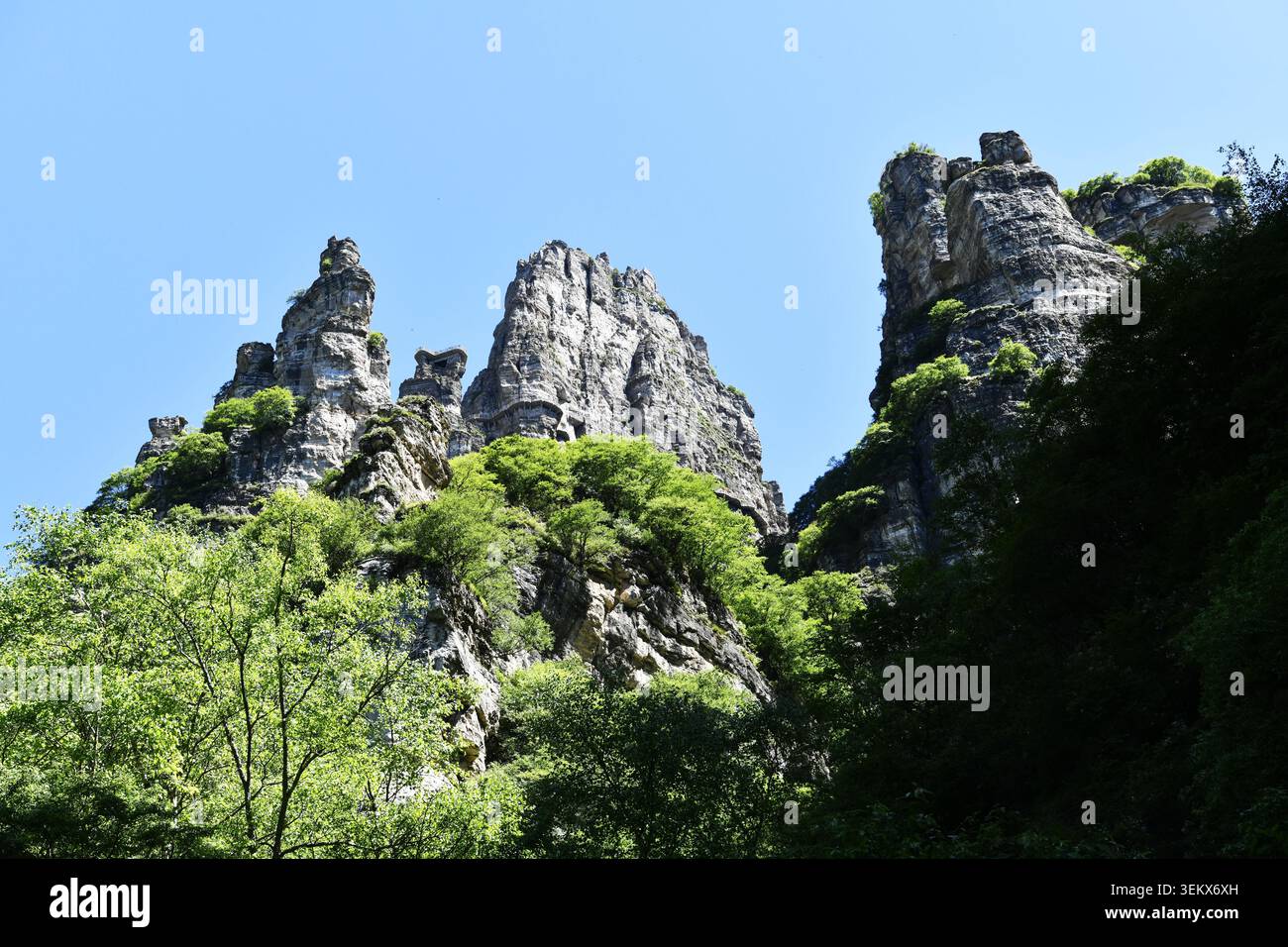 Tourists visit the snow-covered rocks at Baiyun Mountain Scenic Area in ...