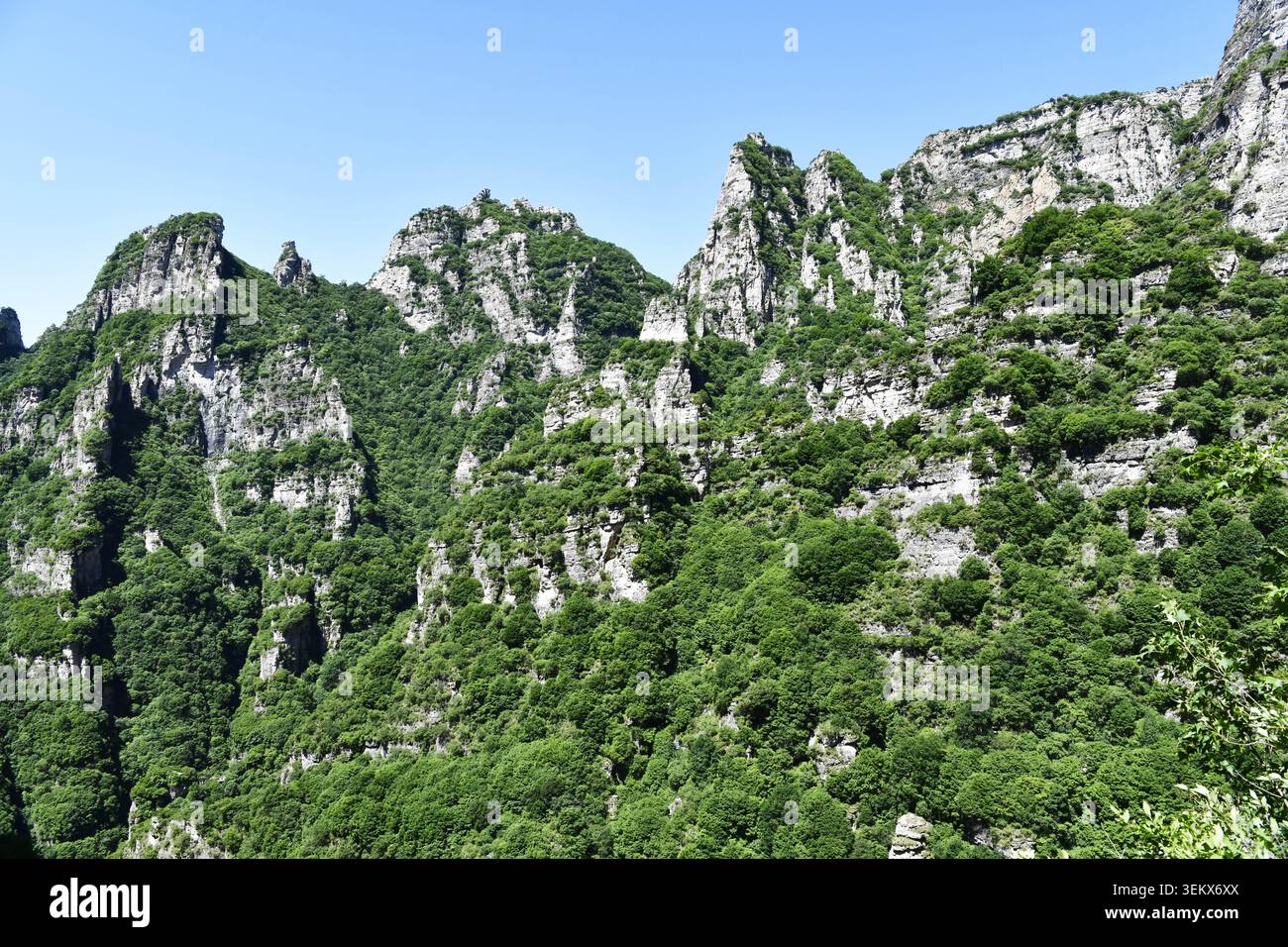 Tourists visit the snow-covered rocks at Baiyun Mountain Scenic Area in ...