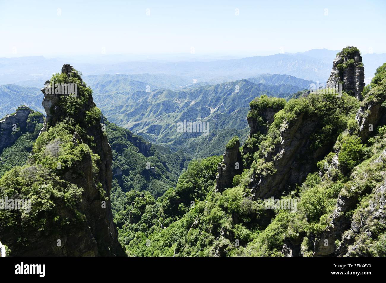 Tourists visit the snow-covered rocks at Baiyun Mountain Scenic Area in ...