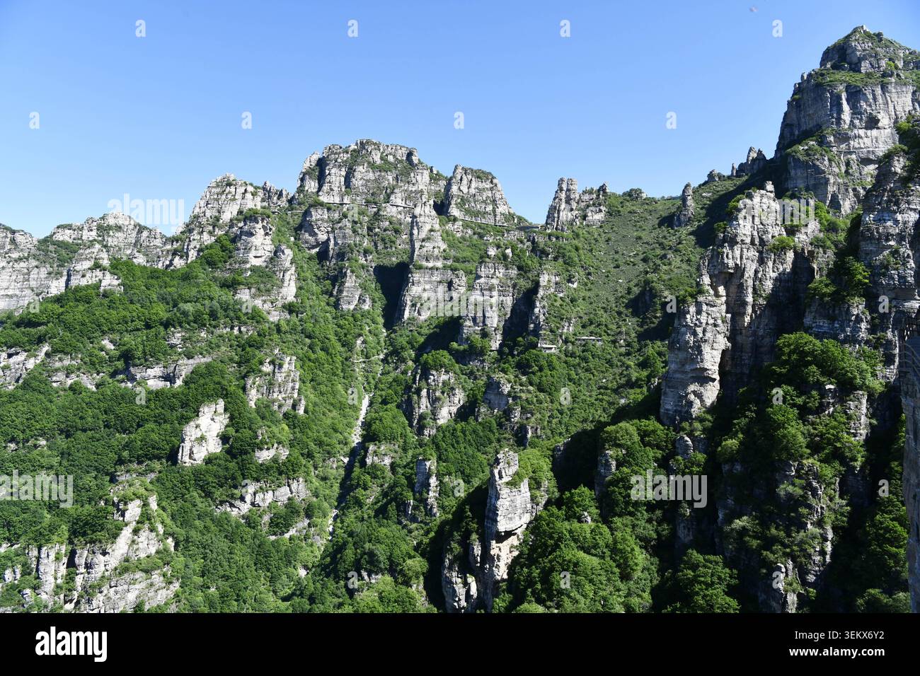 Tourists visit the snow-covered rocks at Baiyun Mountain Scenic Area in ...