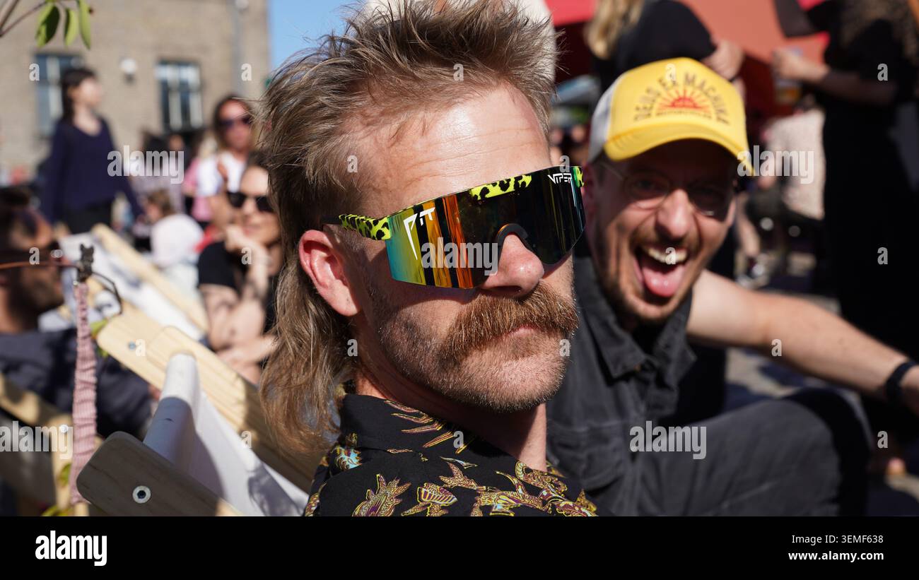 An attendee at Denmark's Mullet Championship looks on in Copenhagen ...