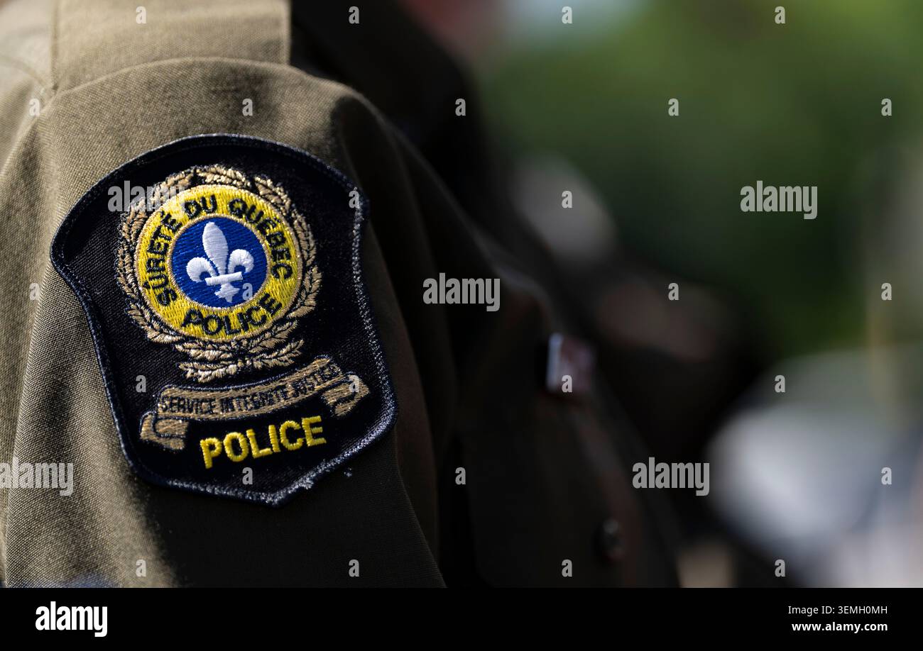 A Surete du Quebec emblem is seen on an officer‚Äôs uniform in Montreal ...