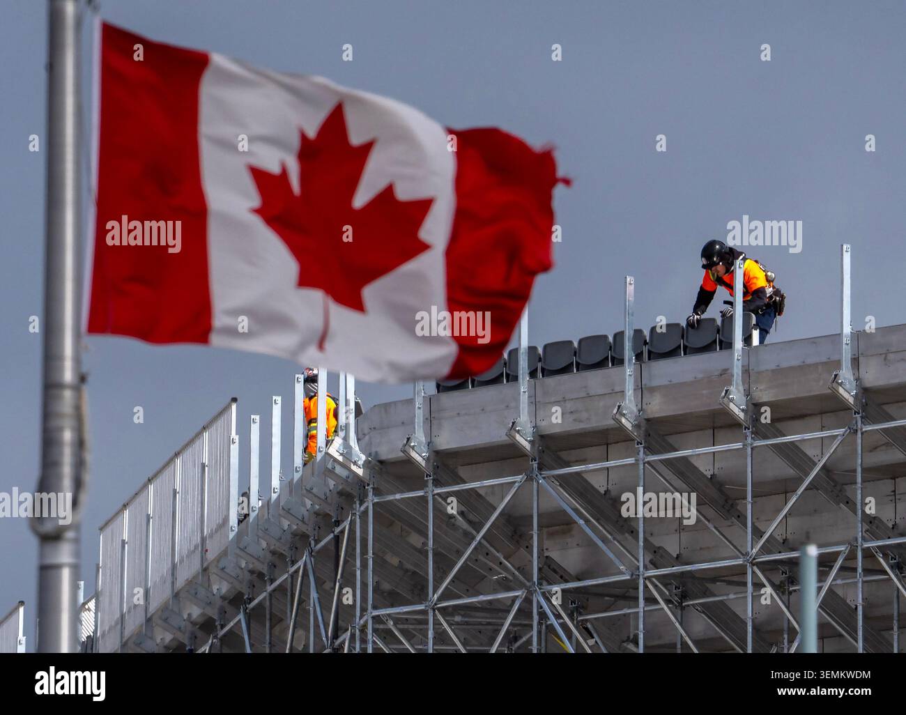 Workers assemble temporary seating high in the air for the FIFA World ...
