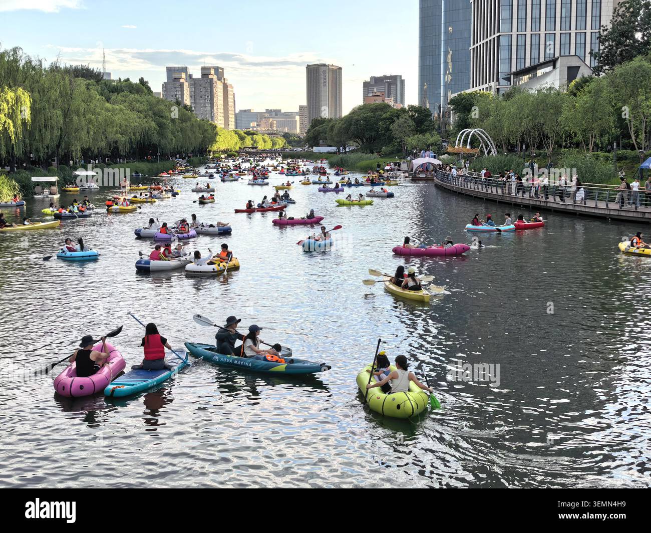 People take boat rides to enjoy the scenery and take photos along the ...
