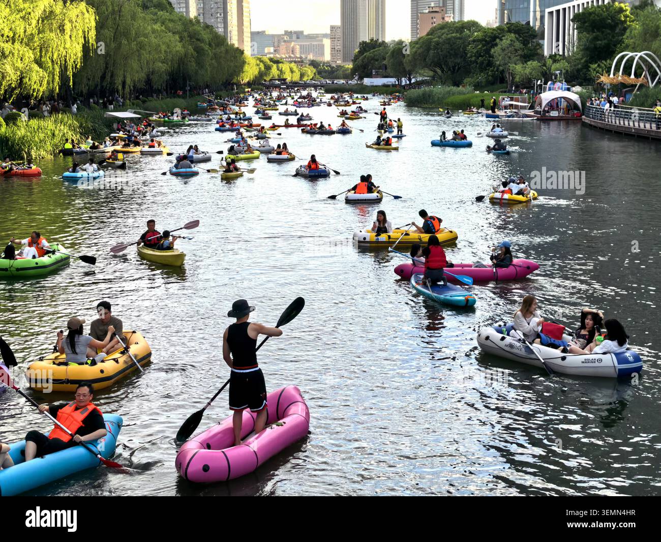People take boat rides to enjoy the scenery and take photos along the ...