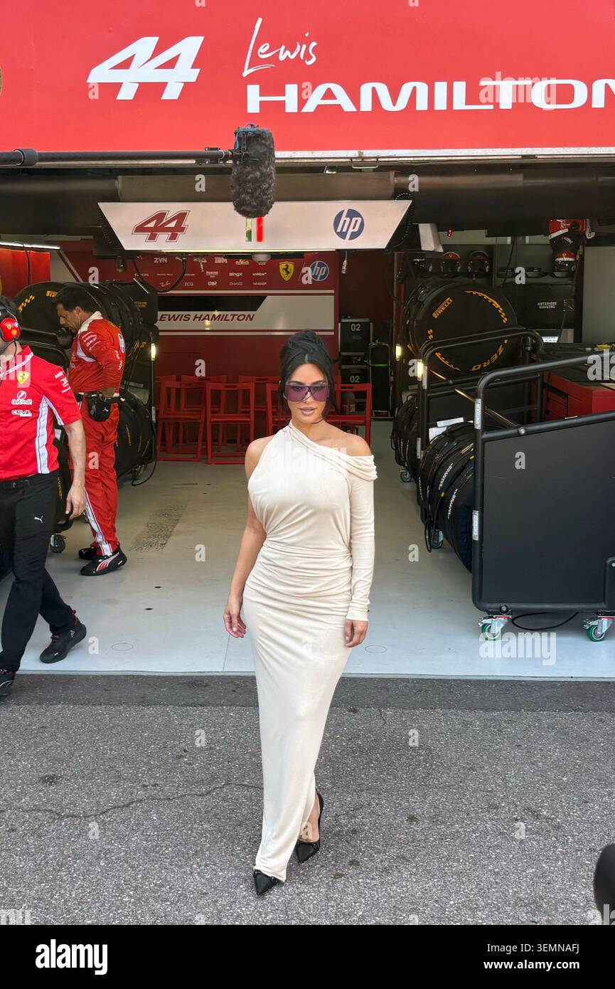 Kim Kardashian standing in front of the garage of Ferrari driver Lewis ...