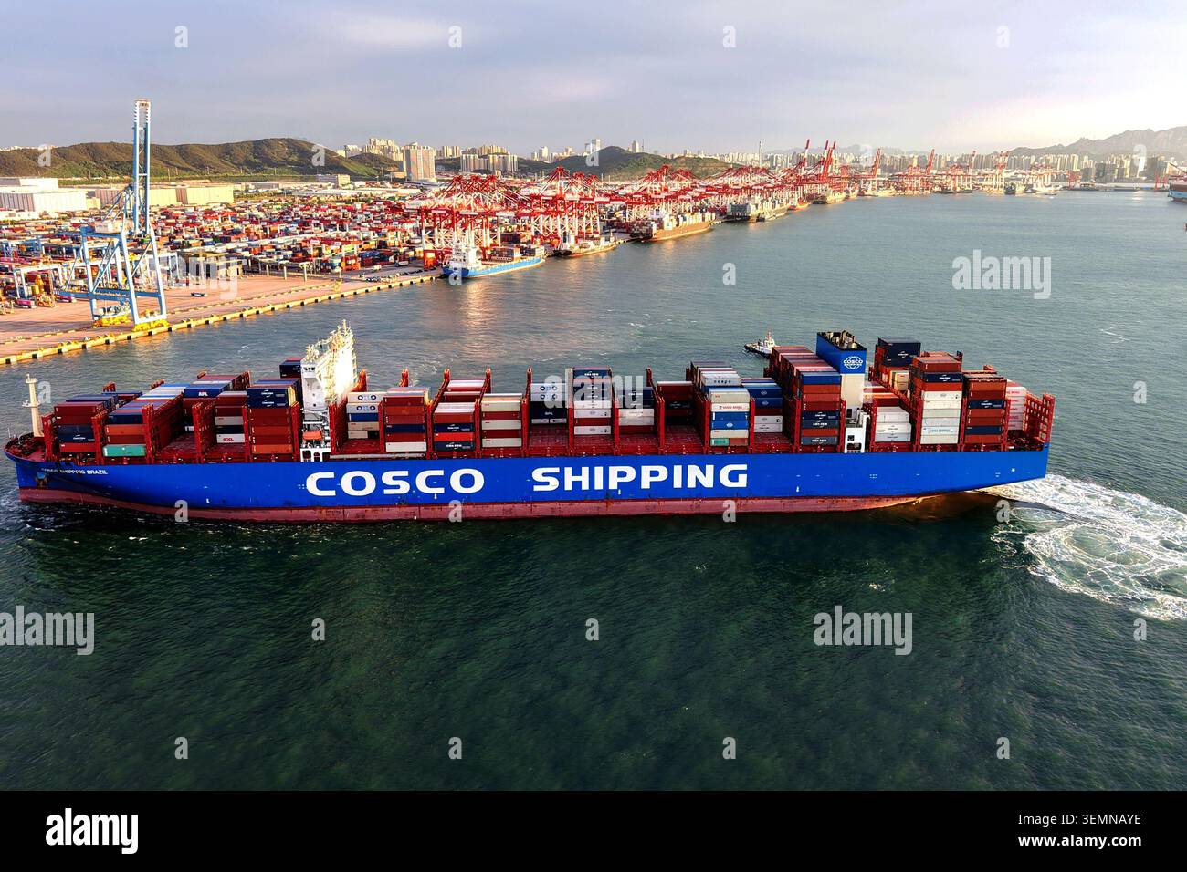 A cargo ship loaded with foreign trade containers departs from berth at ...
