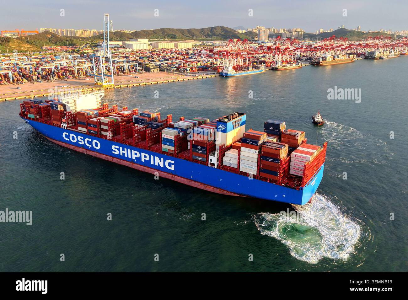 A cargo ship loaded with foreign trade containers departs from berth at ...