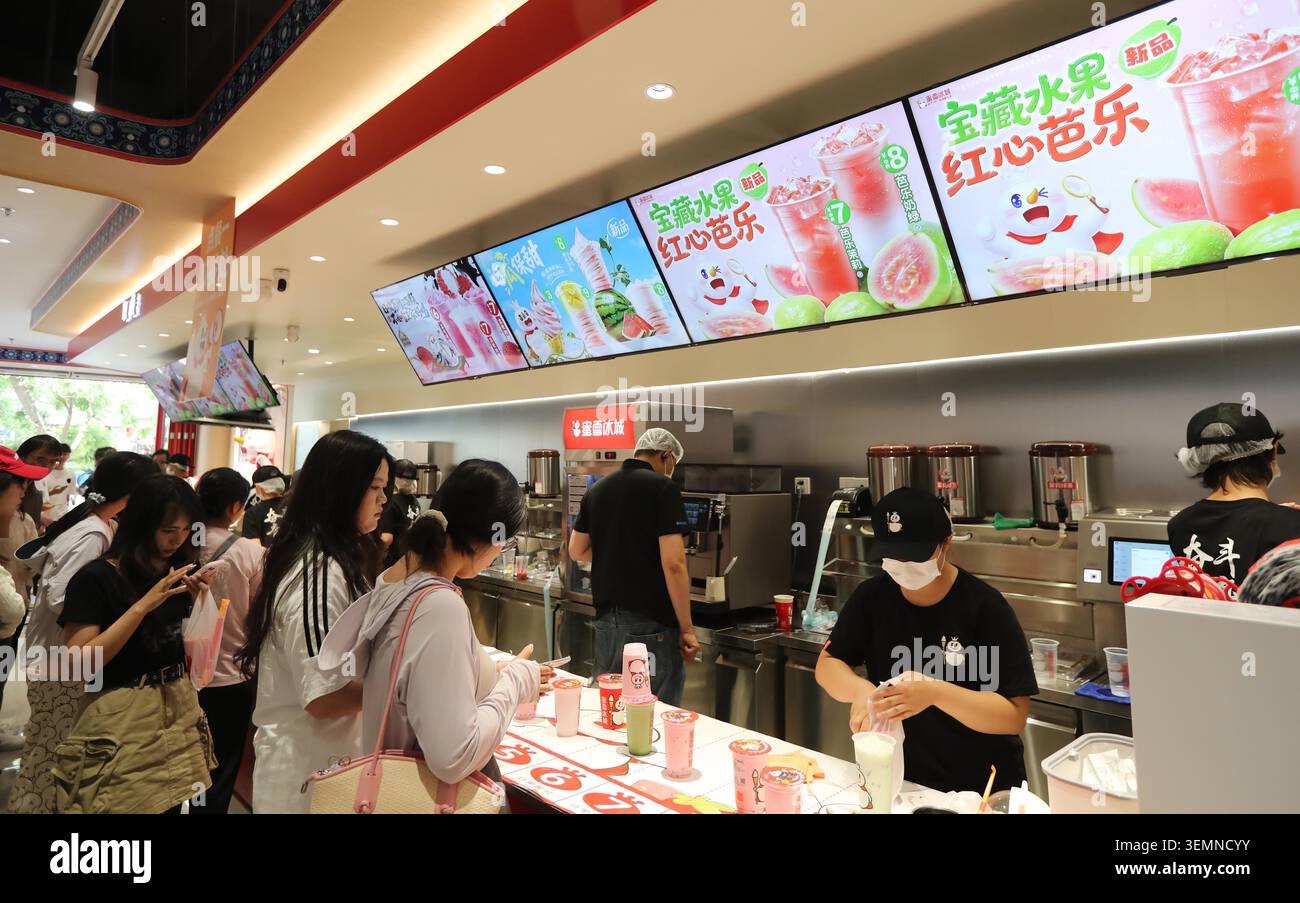 Consumers purchase limited-edition drinks at the Mixue Ice Cream & Tea ...