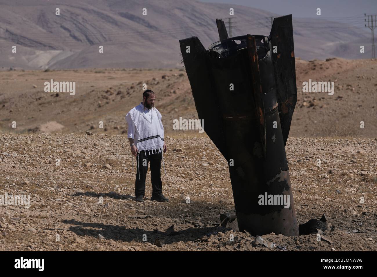 A man look at the wreckage of an Iranian missile that landed near the ...