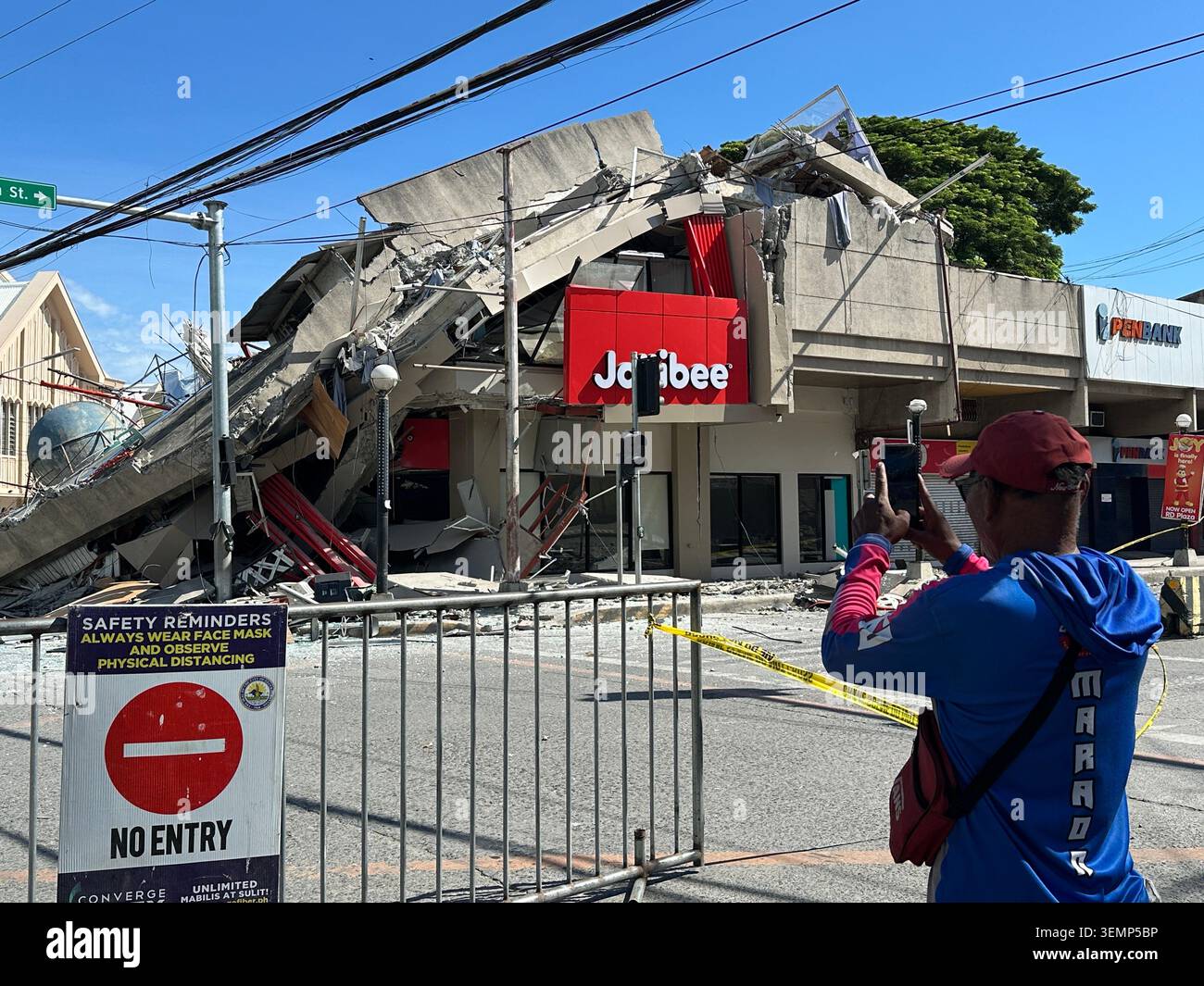 Residents takes a picture of a collapsed structure following an ...