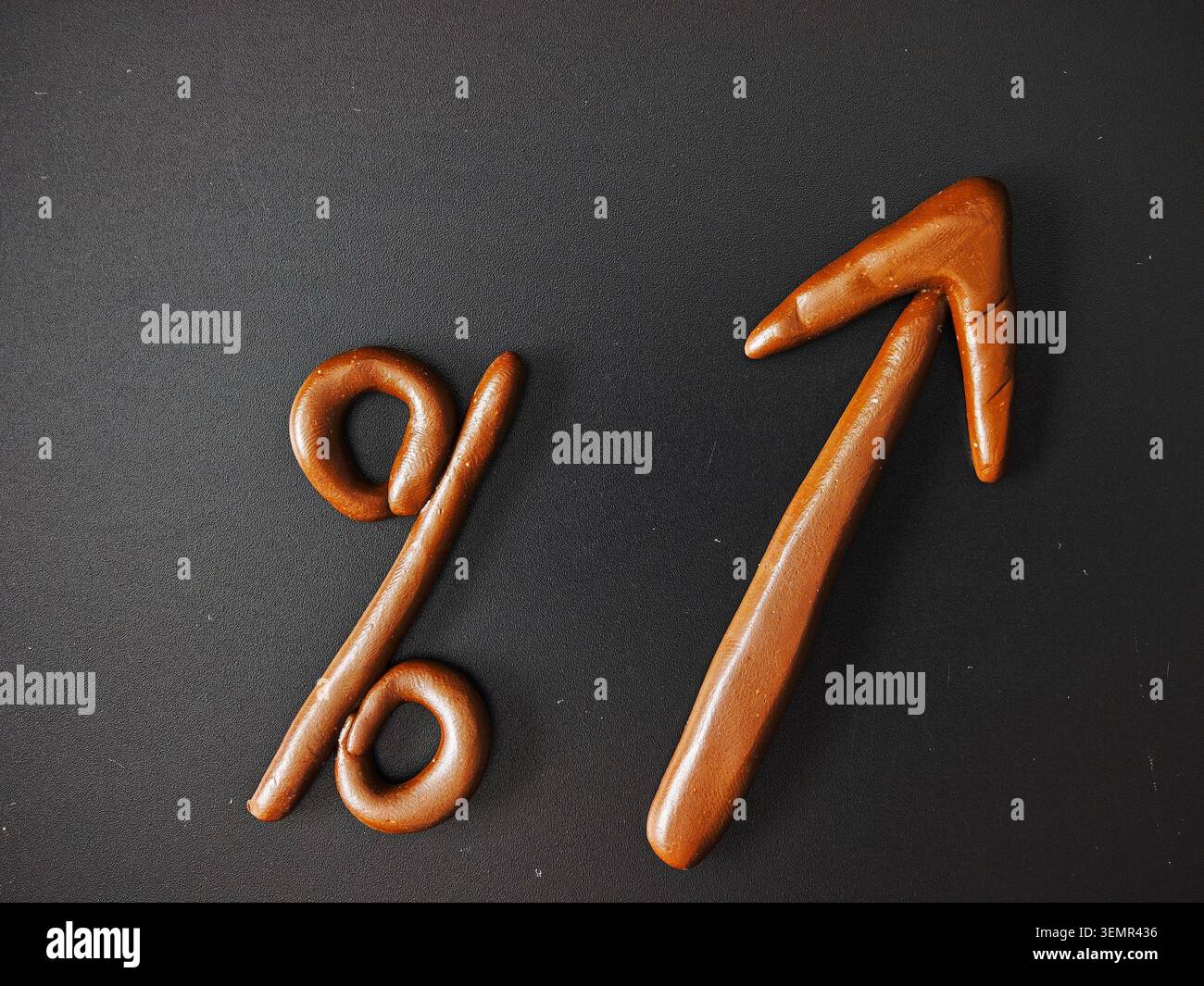 Clay percent sign with upward arrow on dark background illustrating ...