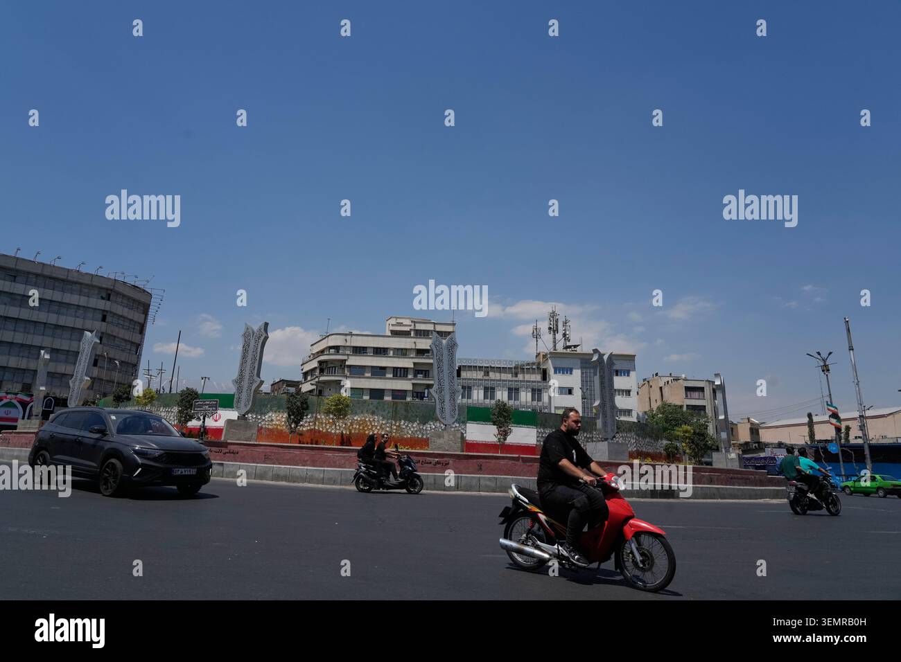 Vehicles drive at the Islamic Revolution square in Tehran, Iran, Monday ...