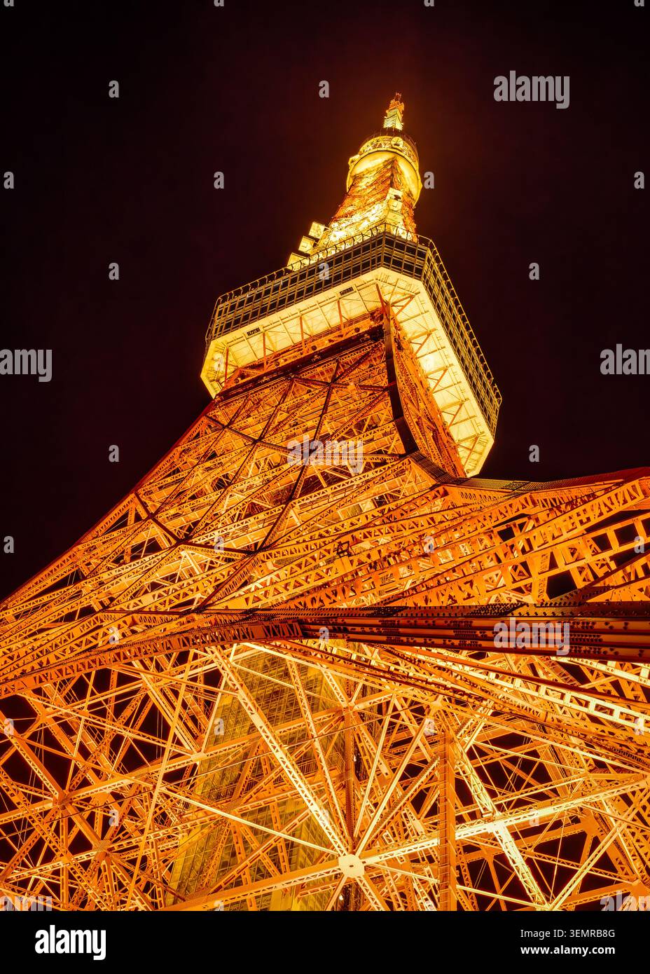 Tokyo Tower rises sharply into the night sky, its lattice structure ...