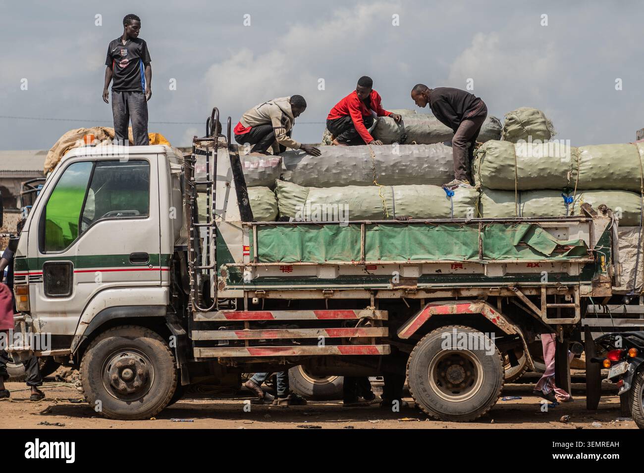 Workers load a truck with goods at the station in Bunia, Congo, Monday ...