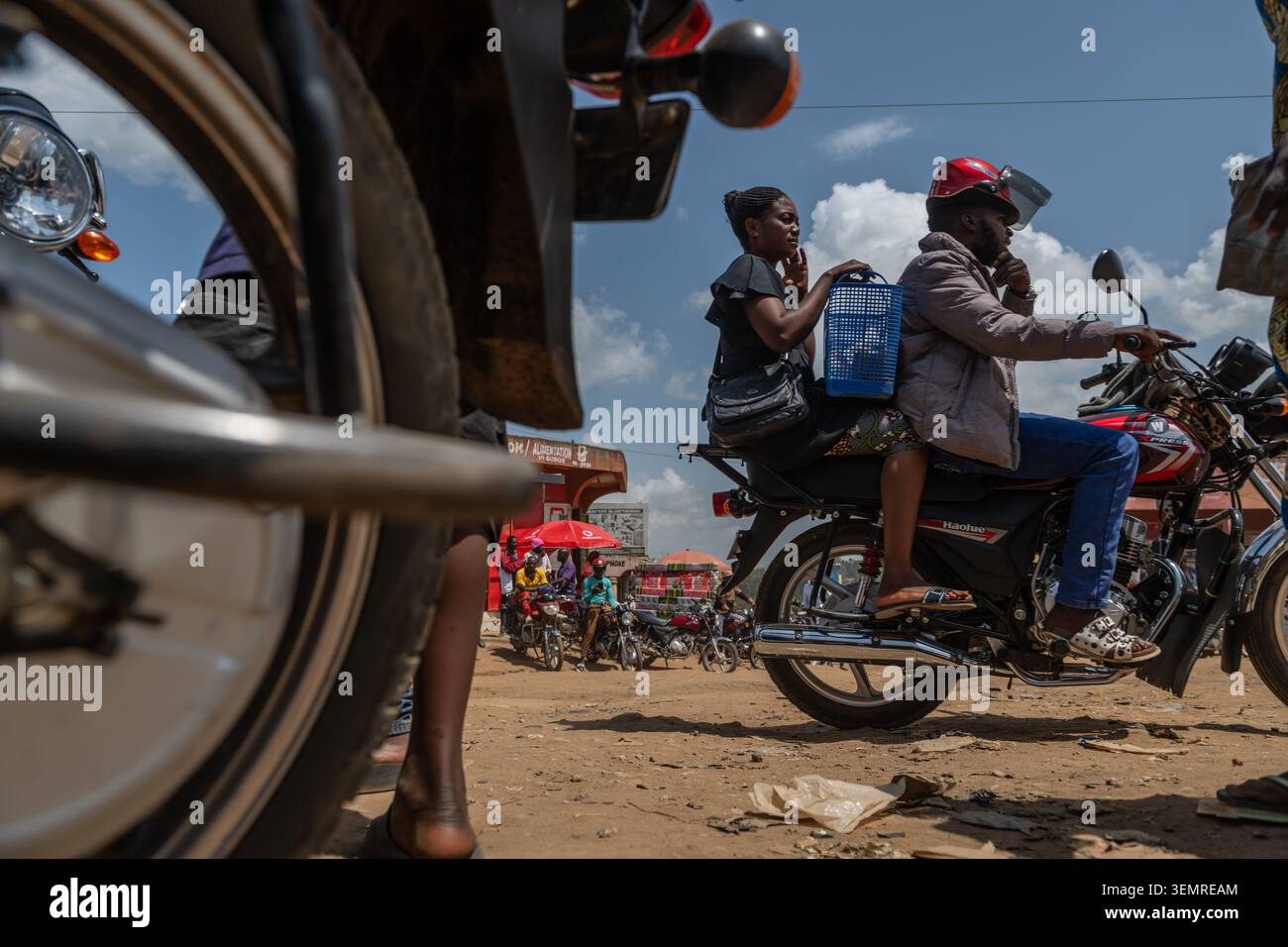 A motorcycle taxi rider transports a passenger in Bunia, Congo, Monday ...