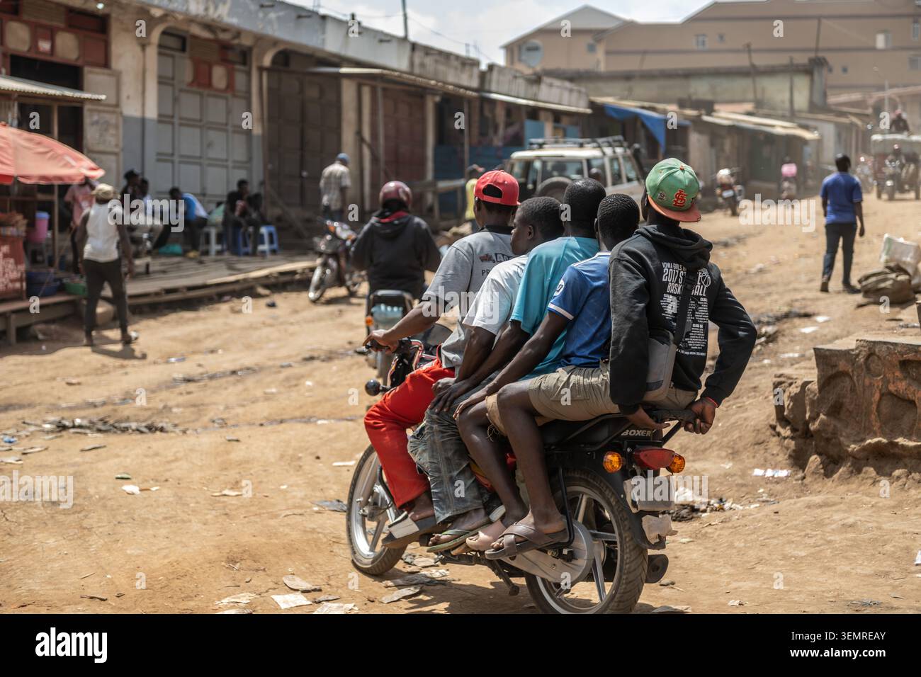 A motorcycle taxi rider transports passengers in Bunia, Congo, Monday ...