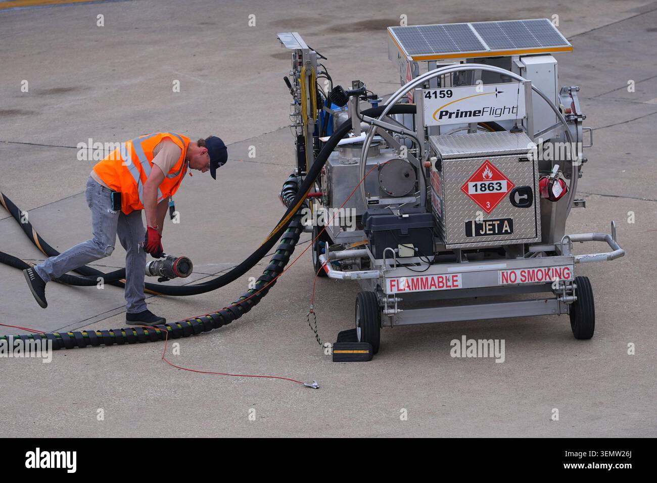 FILE - A worker finishes up fueling a jet at DFW International Airport ...