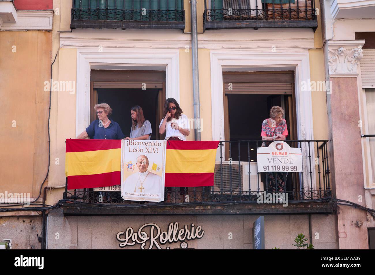Pope Leo XIV waves to supporters as his motorcade passes through Madrid ...