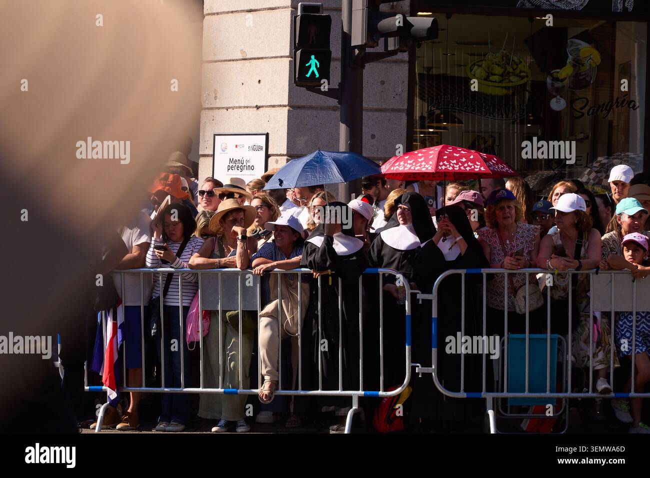 Pope Leo XIV waves to supporters as his motorcade passes through Madrid ...