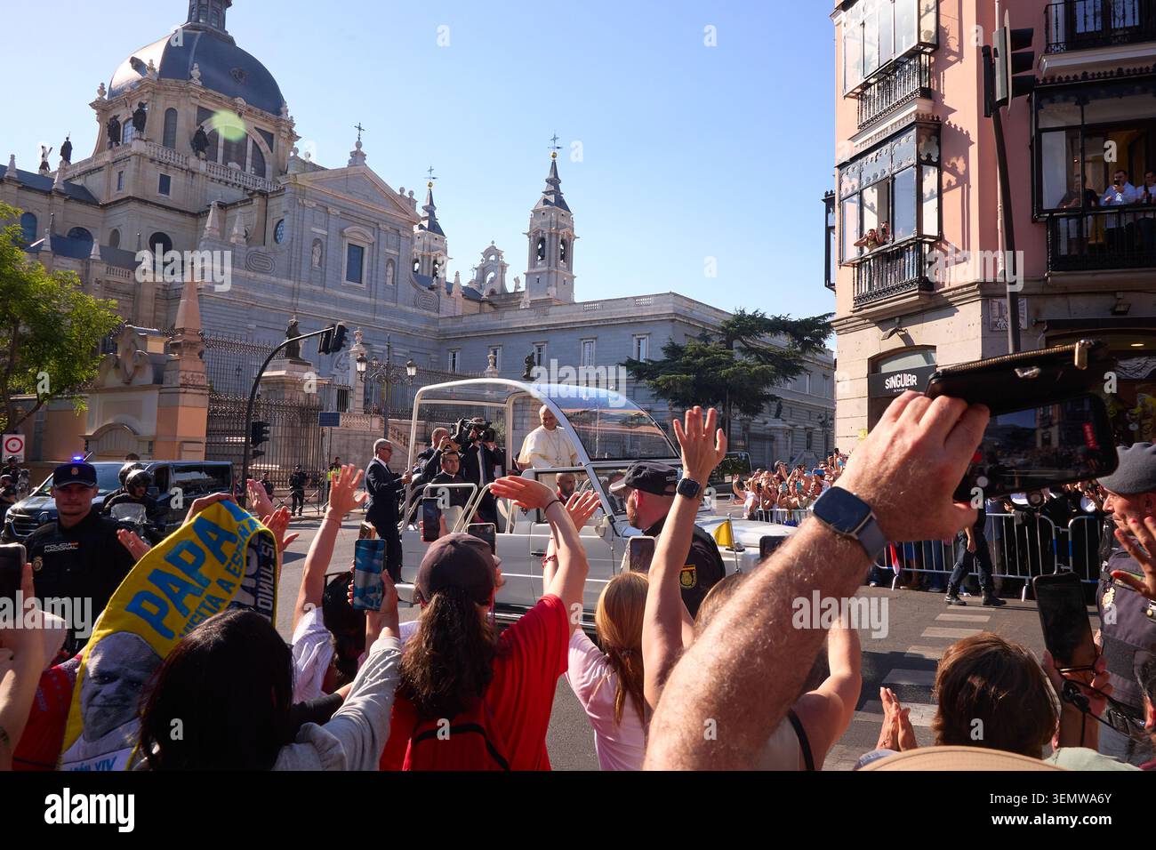 Pope Leo XIV waves to supporters as his motorcade passes through Madrid ...