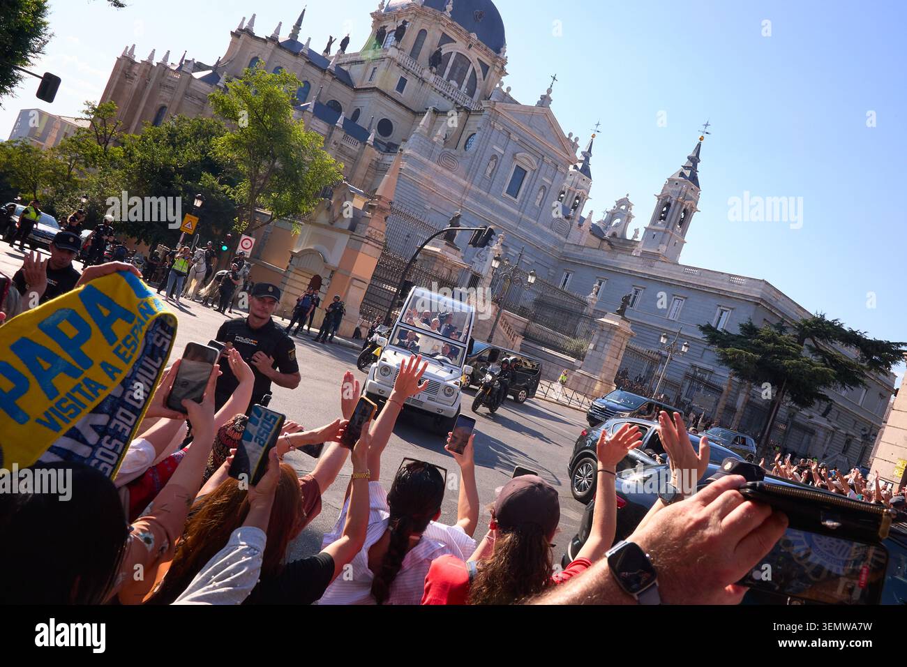 Pope Leo XIV waves to supporters as his motorcade passes through Madrid ...